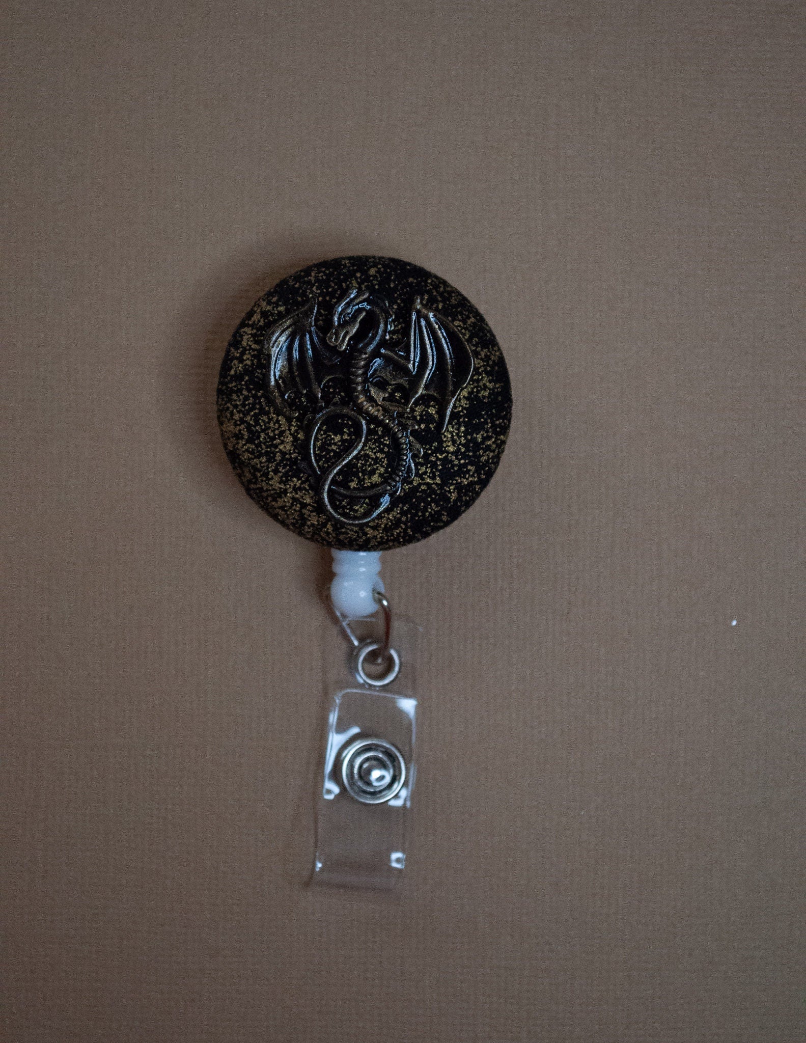 Black and gold dragon badge reel – Rowan Gate